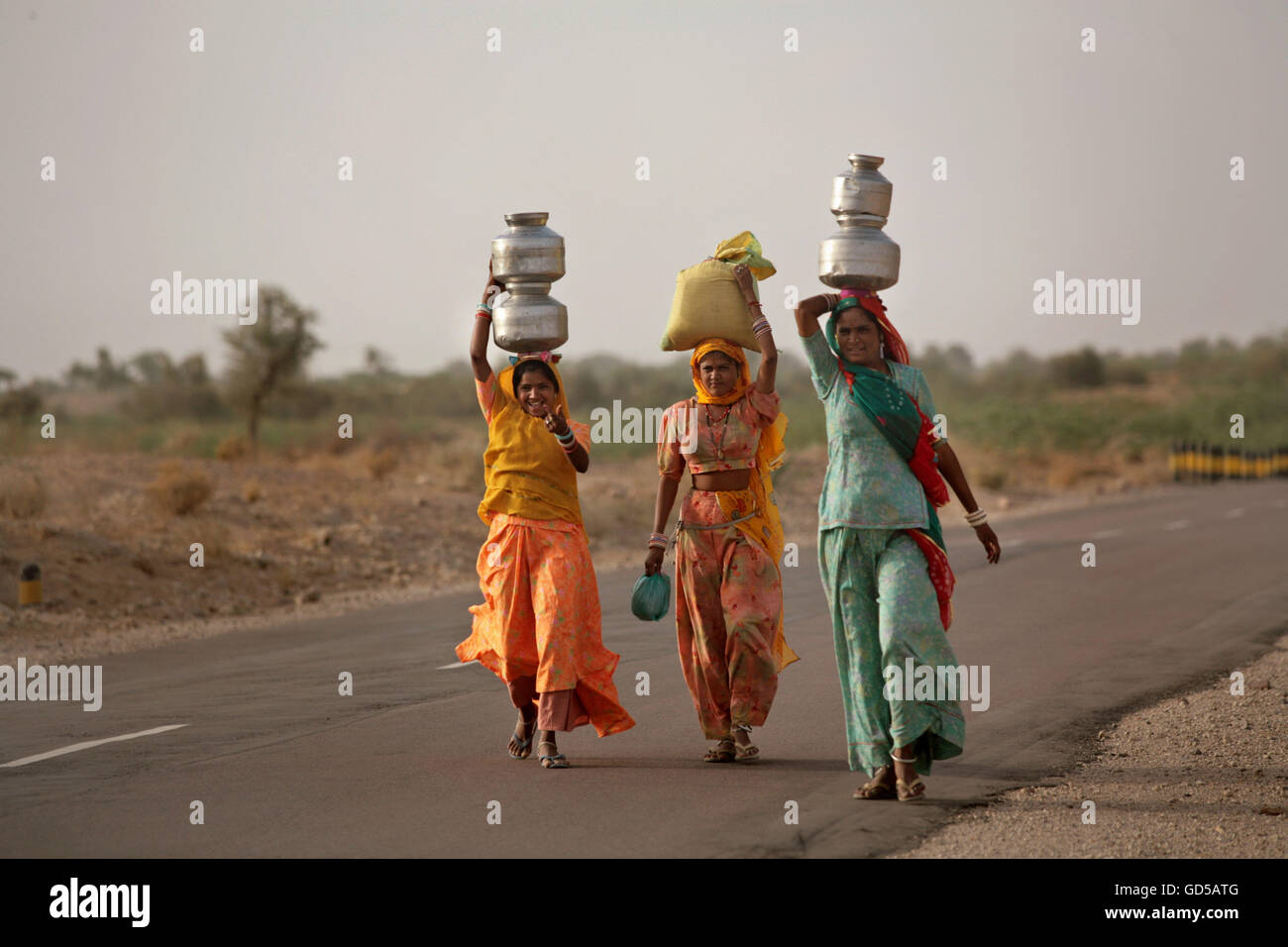 Women fetching water Stock Photo - Alamy