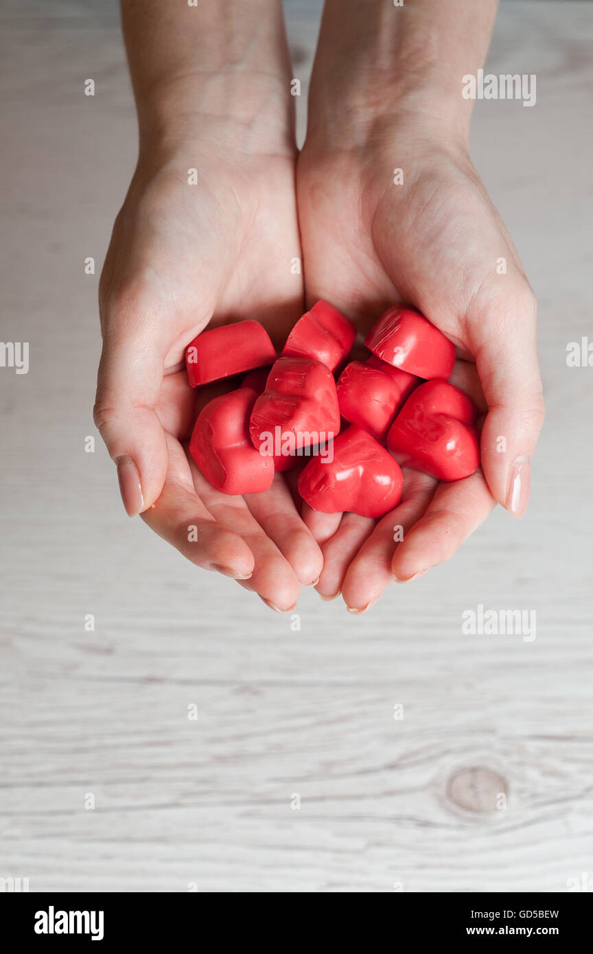 woman's hands full of chocolate sweets Stock Photo - Alamy