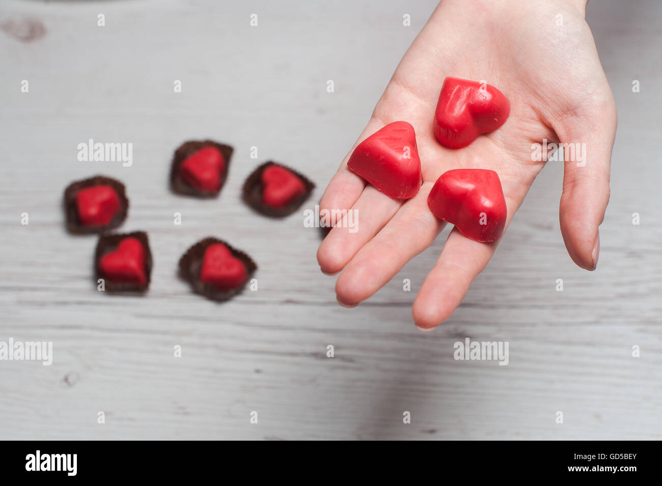 woman's hands full of chocolate sweets Stock Photo - Alamy