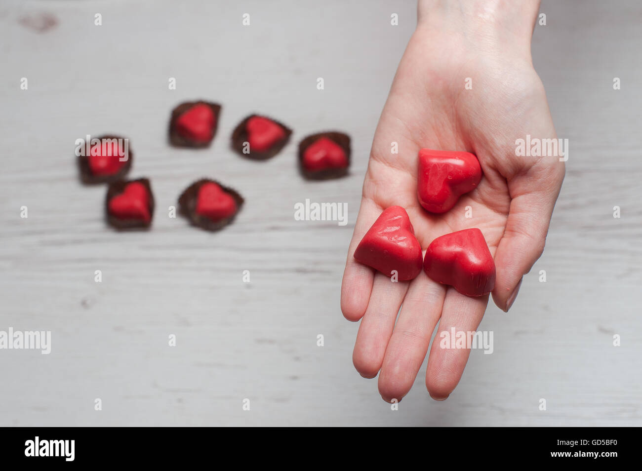 woman's hands full of chocolate sweets Stock Photo - Alamy