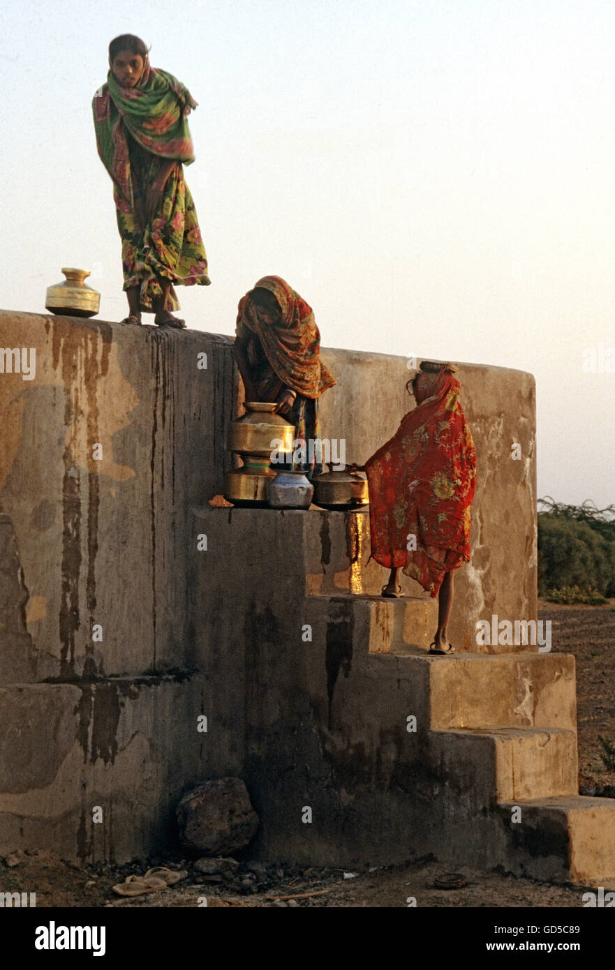 Girls fetching water Stock Photo - Alamy
