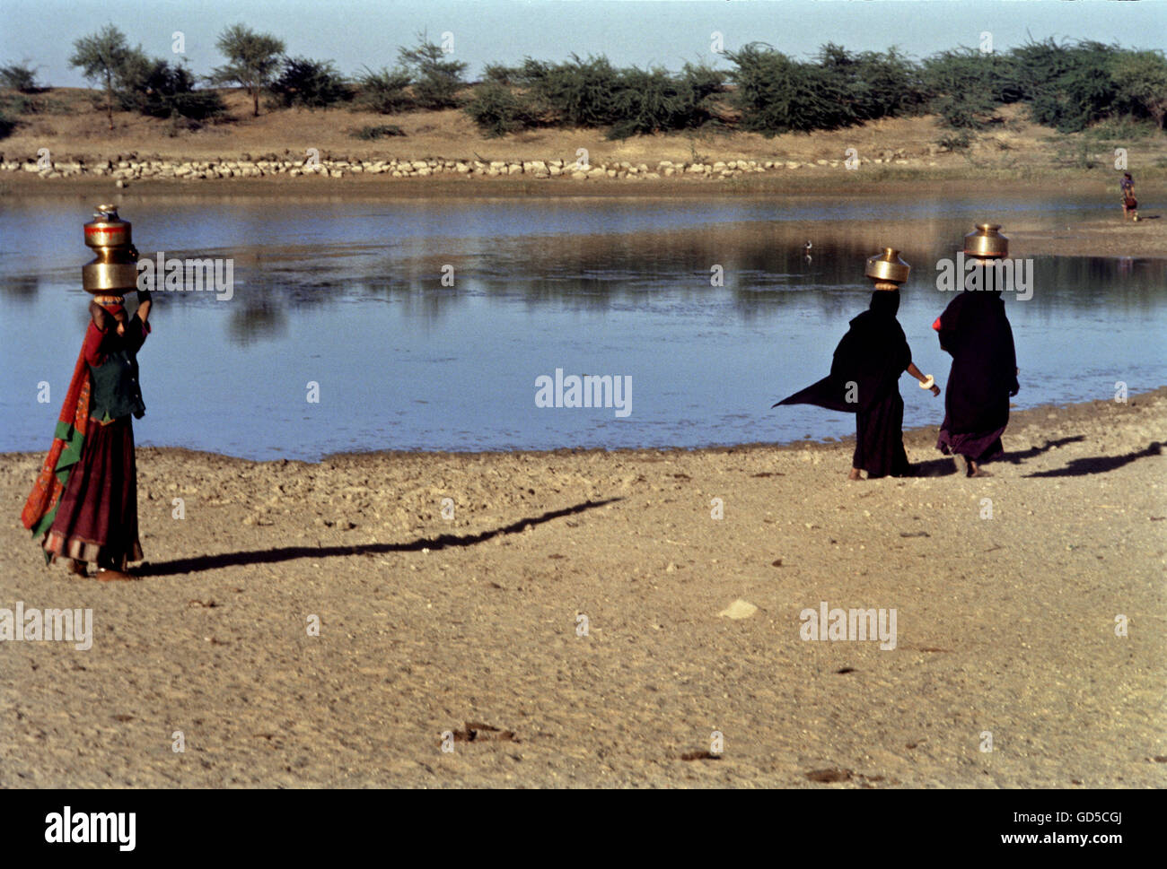 Women fetching water Stock Photo - Alamy