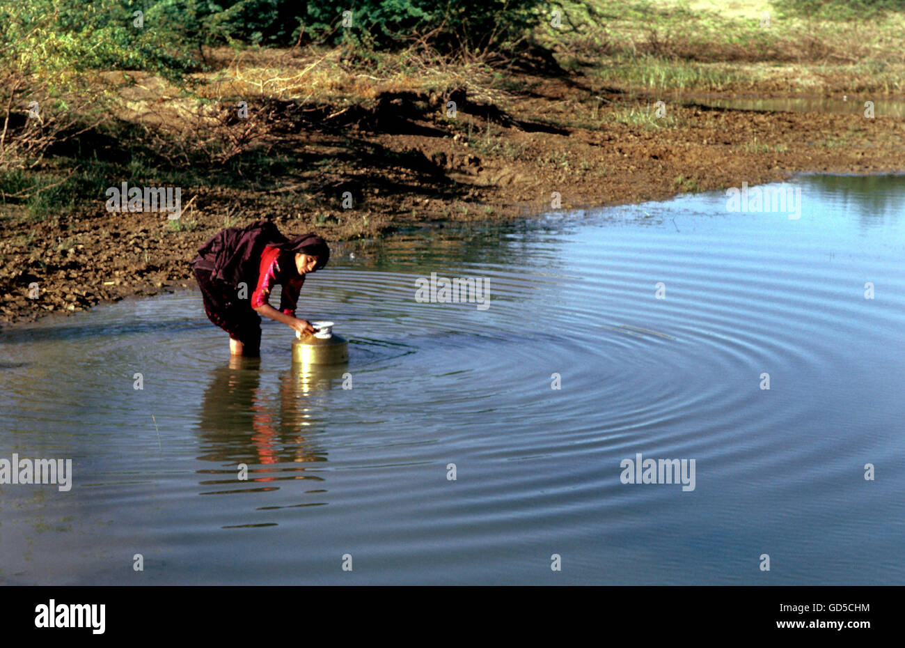 India woman fetching water stream hi-res stock photography and images ...
