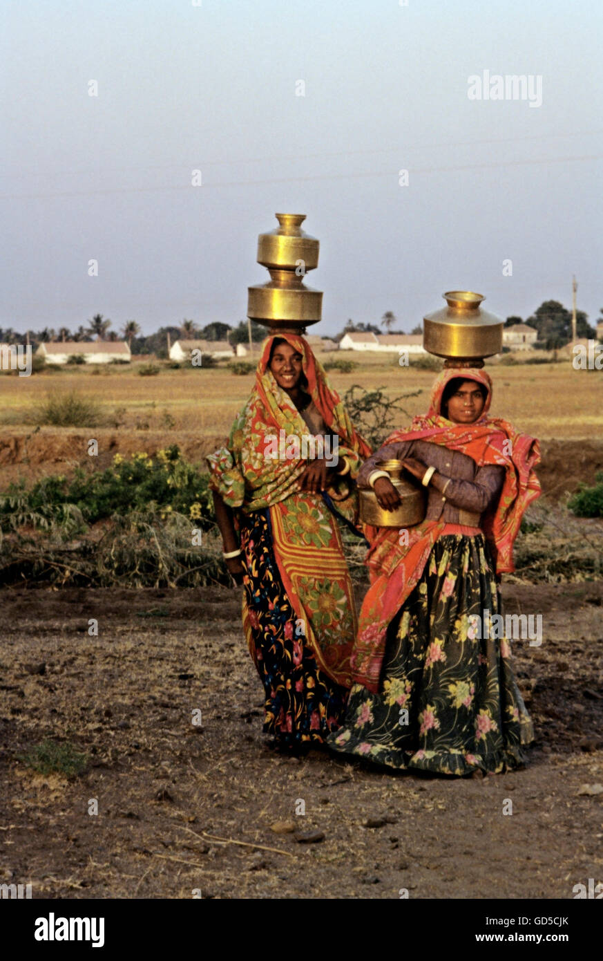 Women fetching water Stock Photo - Alamy
