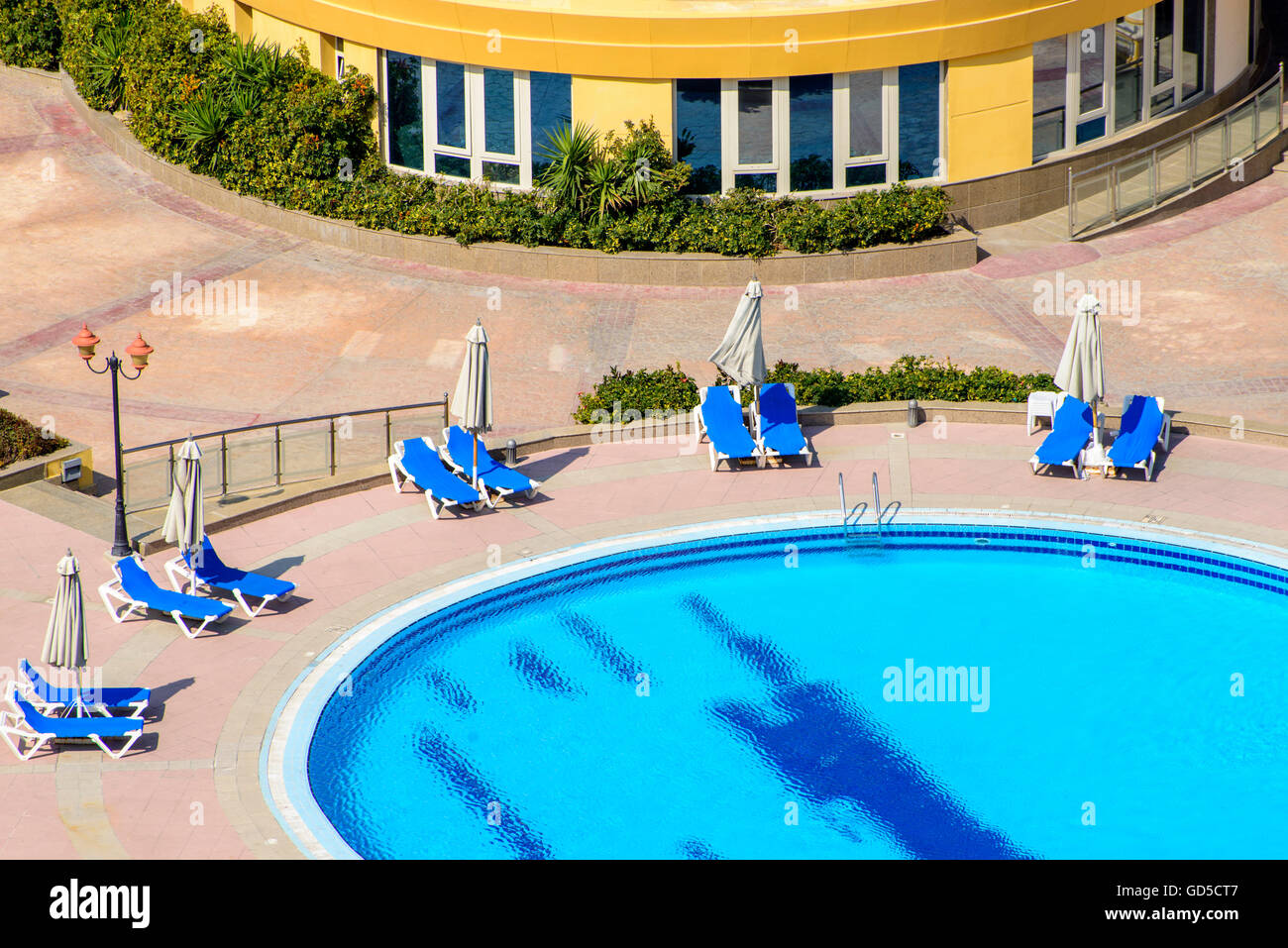 Blue Resting Chairs at Swimming Pool Under Sunlight Stock Photo - Alamy