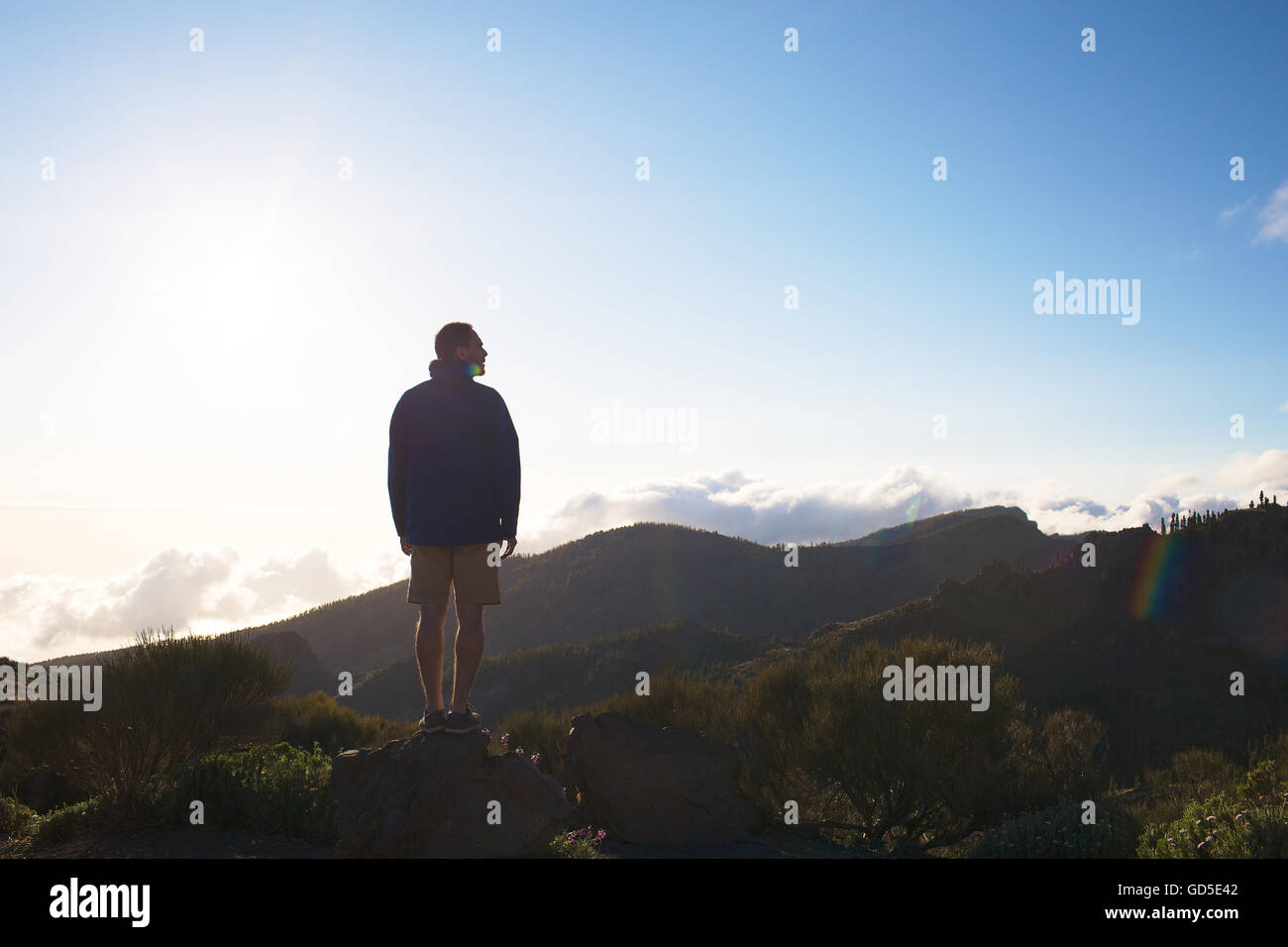 Man on stone Stock Photo - Alamy