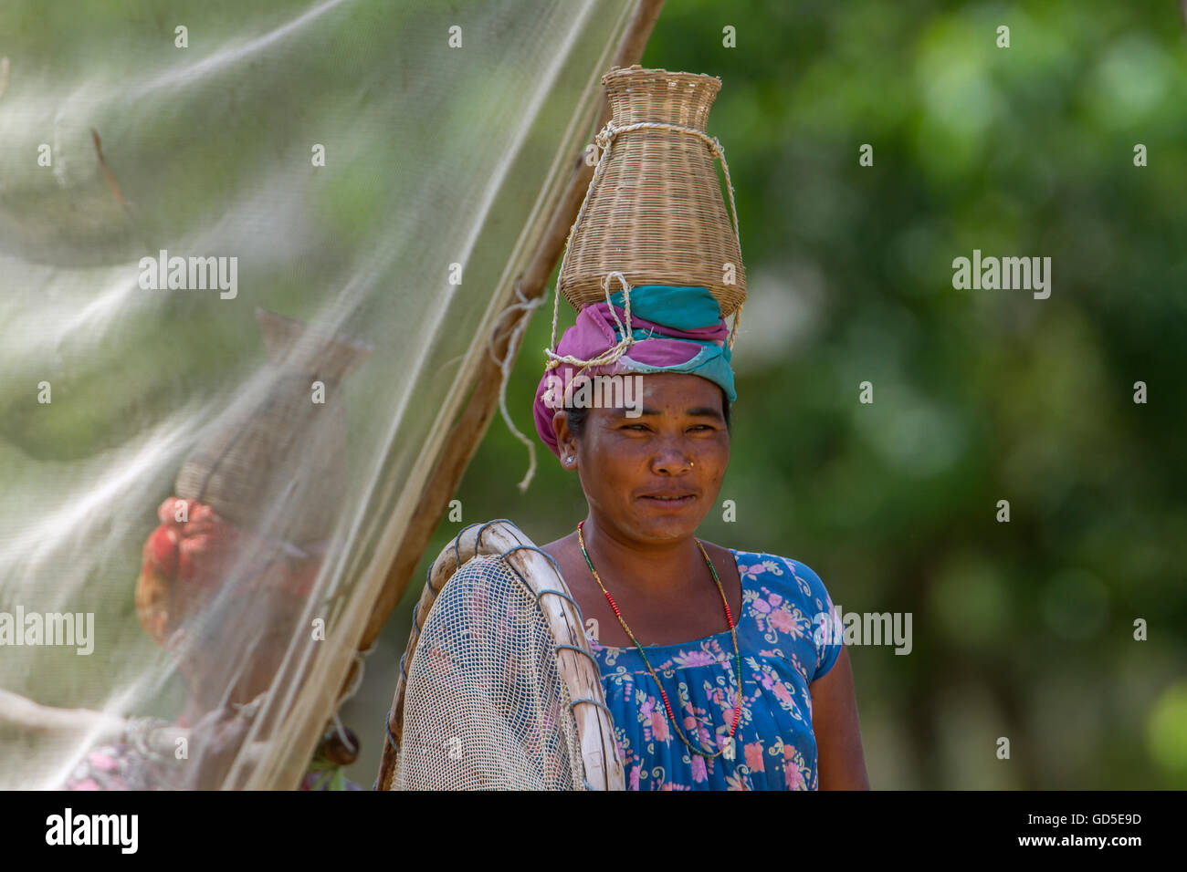 Tharu woman in nepali terai wearing traditional clothing to go fishing ...