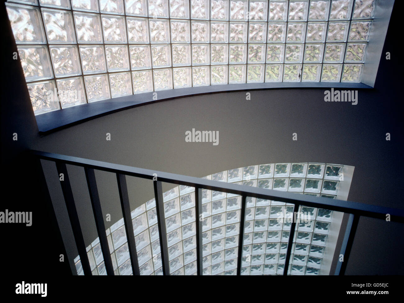 Sun streaming through block glass wall in a stairwell, American College ...