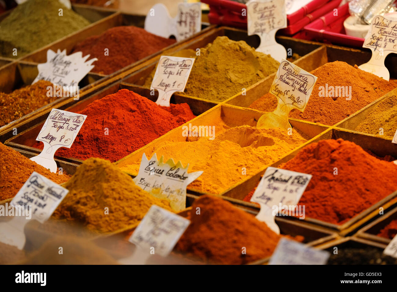 A market stall display of assorted fresh colourful spices on an open ...