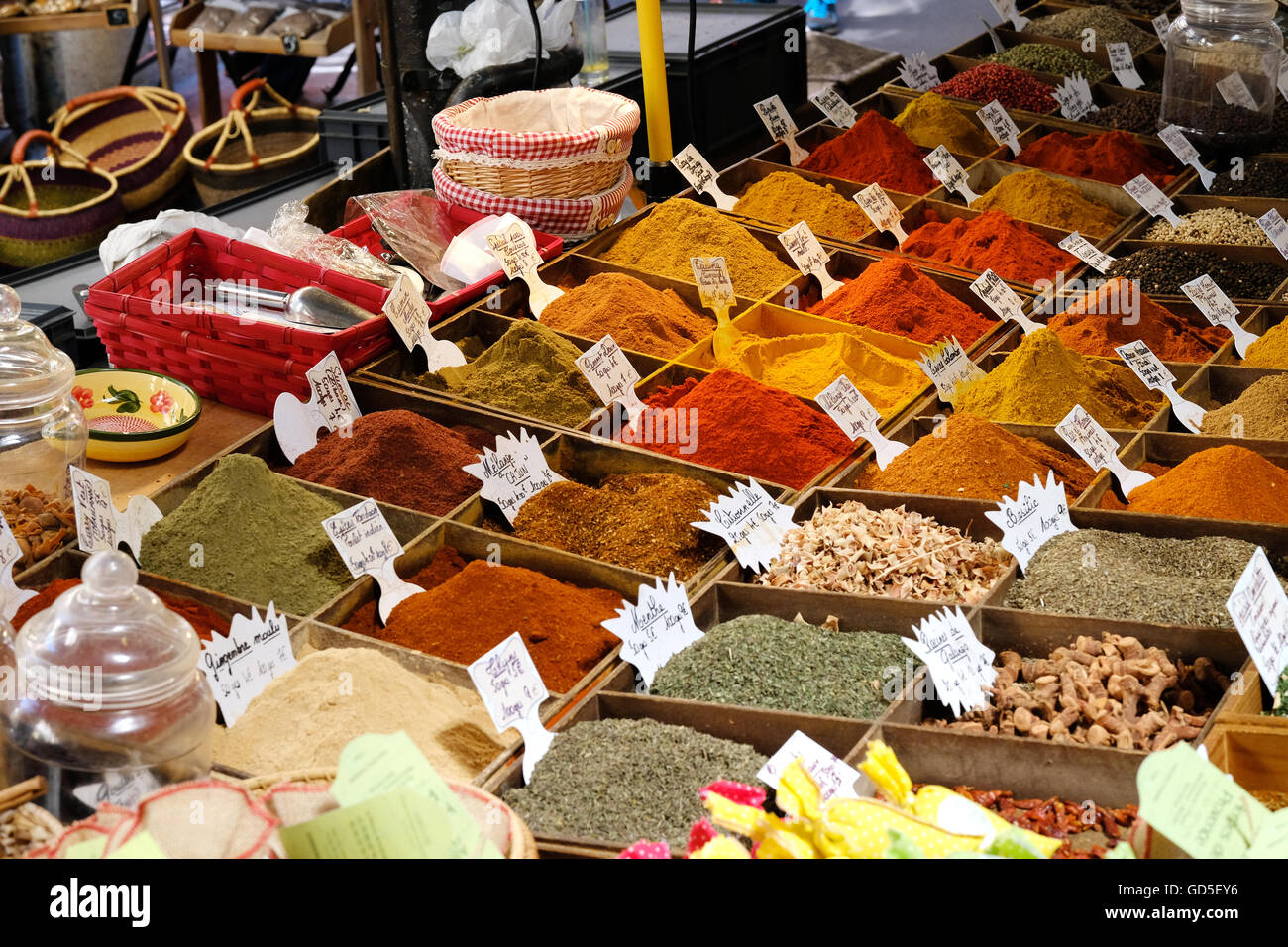 A market stall display of assorted fresh colourful spices on an open ...