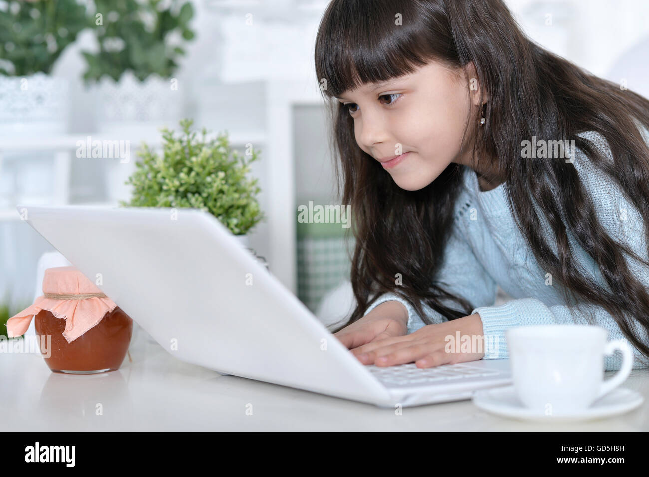 Little girl using computer Stock Photo - Alamy