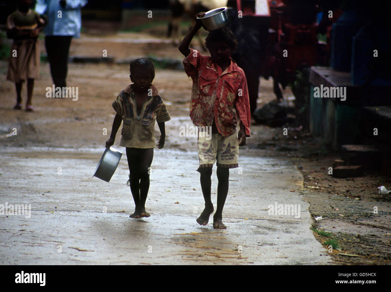 Boys walking with pots Stock Photo - Alamy