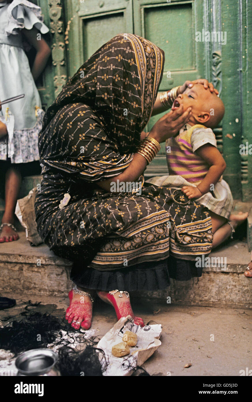 Woman feeding child Stock Photo - Alamy