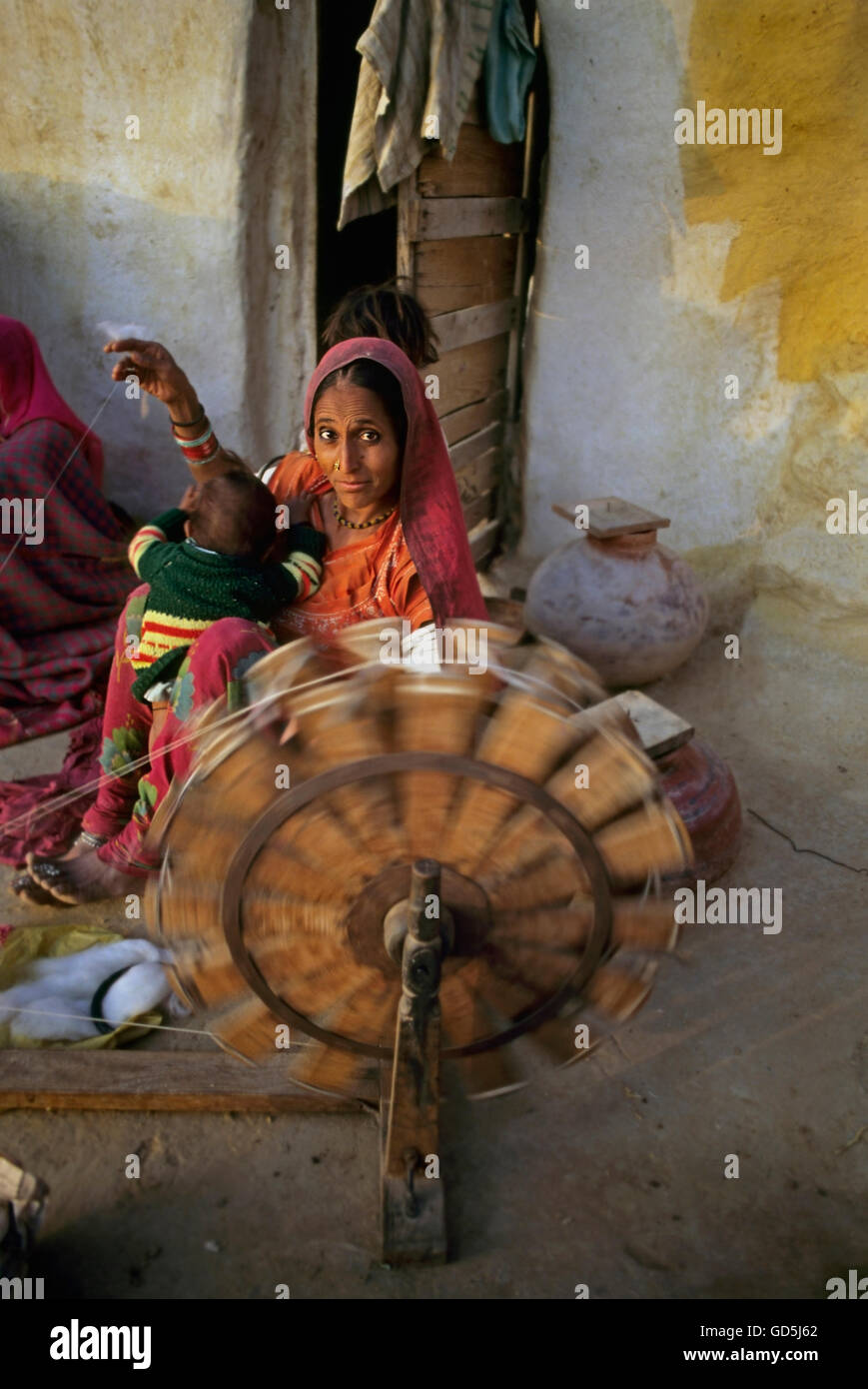 Woman with charkha Stock Photo - Alamy