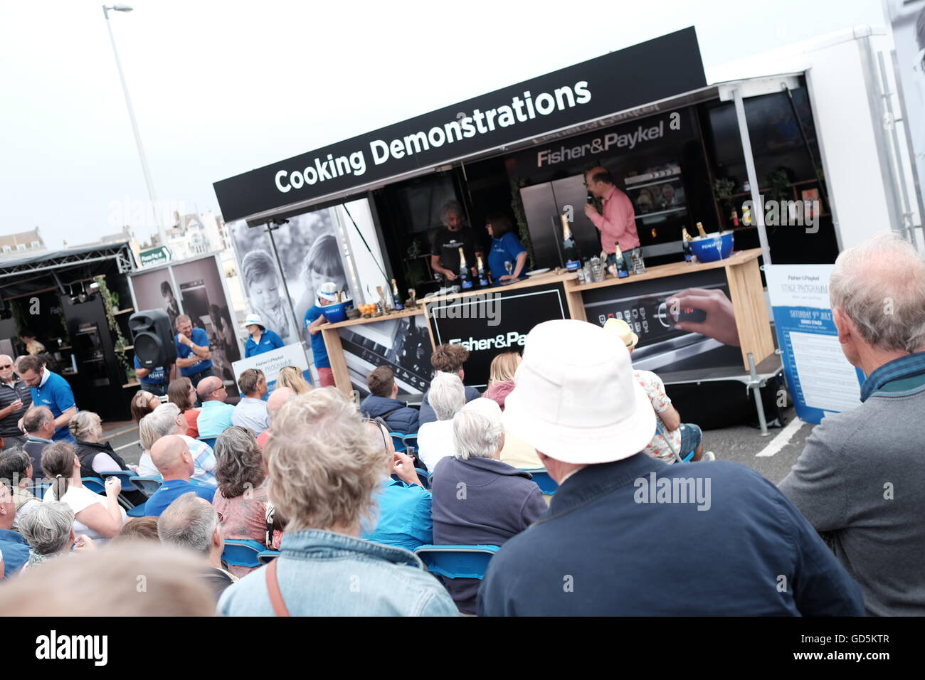 crowds watching outdoor cooking demonstration Stock Photo - Alamy
