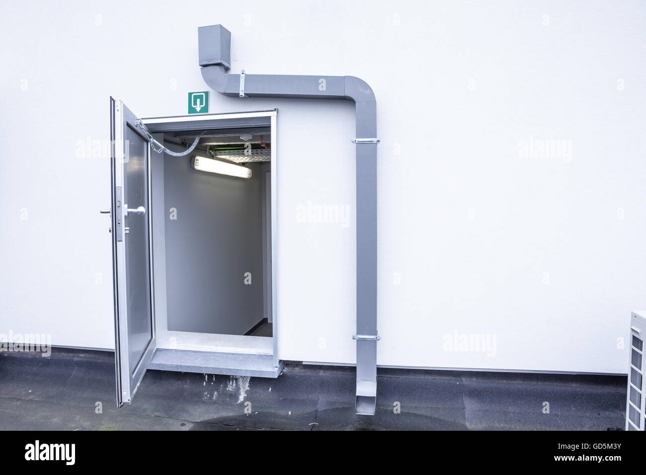 an small emergency exit door at the end of the corridor Stock Photo - Alamy