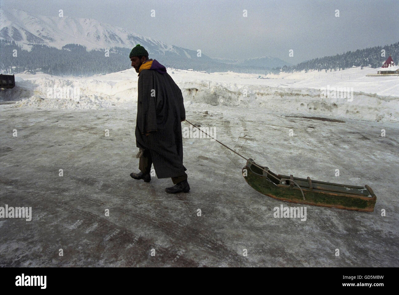 Man pulling a sledge Stock Photo - Alamy