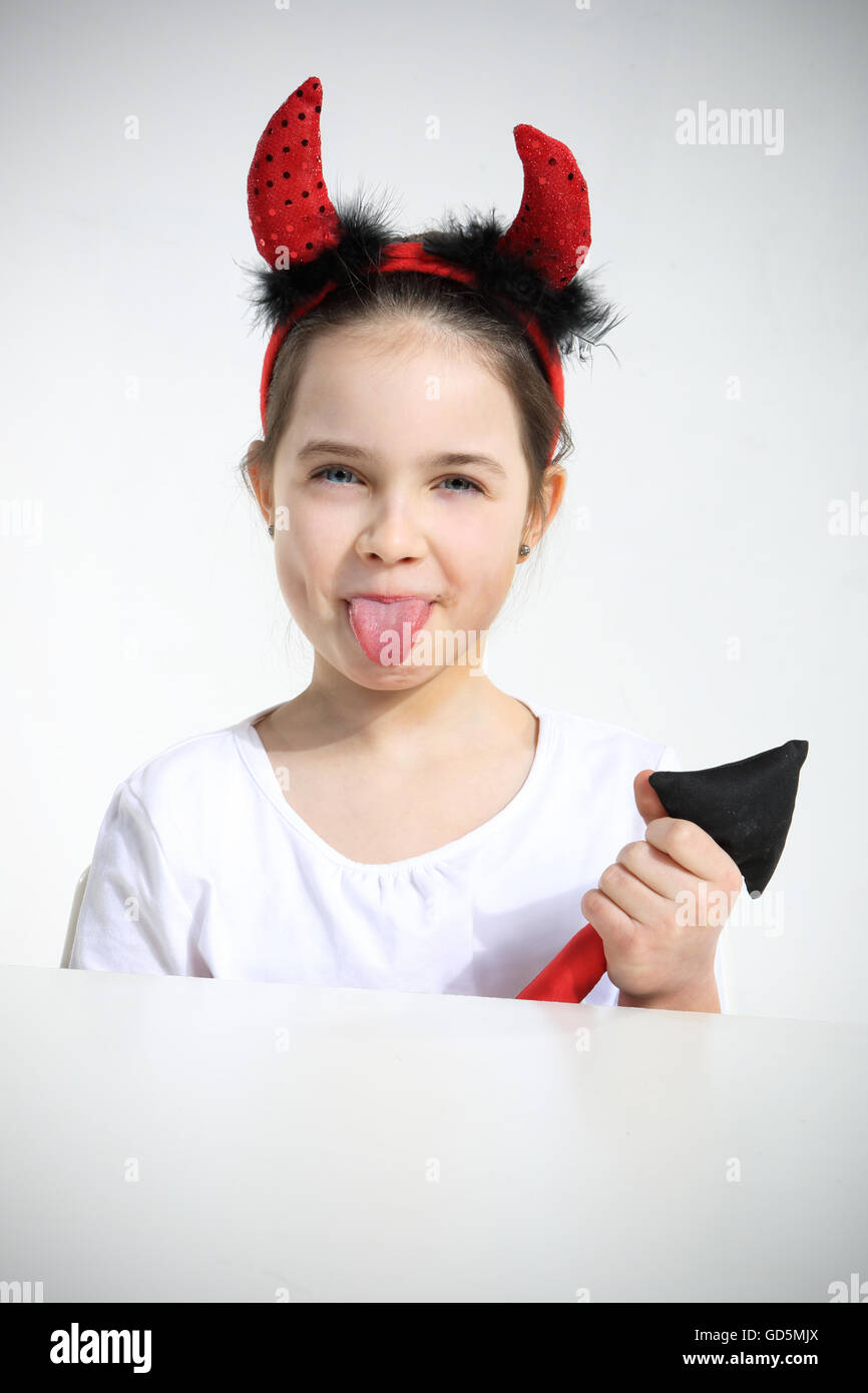 Little girl dressed as pretty imp in studio Stock Photo - Alamy