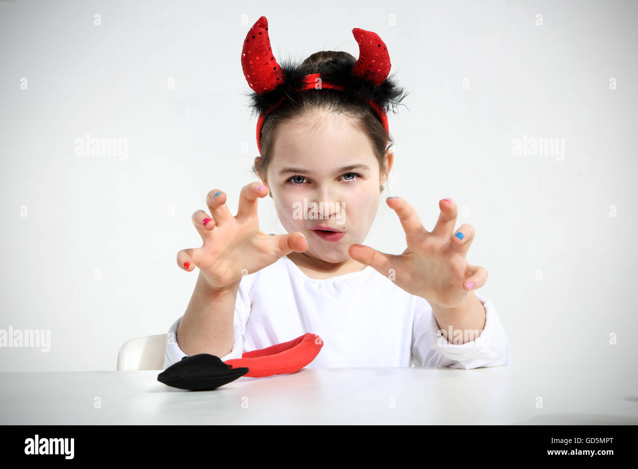 Little girl dressed as pretty imp in studio Stock Photo - Alamy