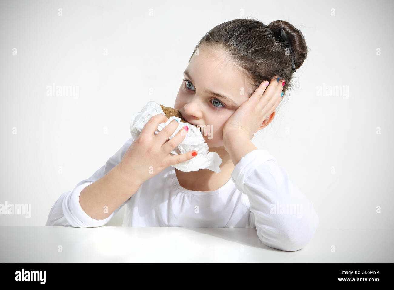 Beautiful girl eating bread isolated on white Stock Photo - Alamy