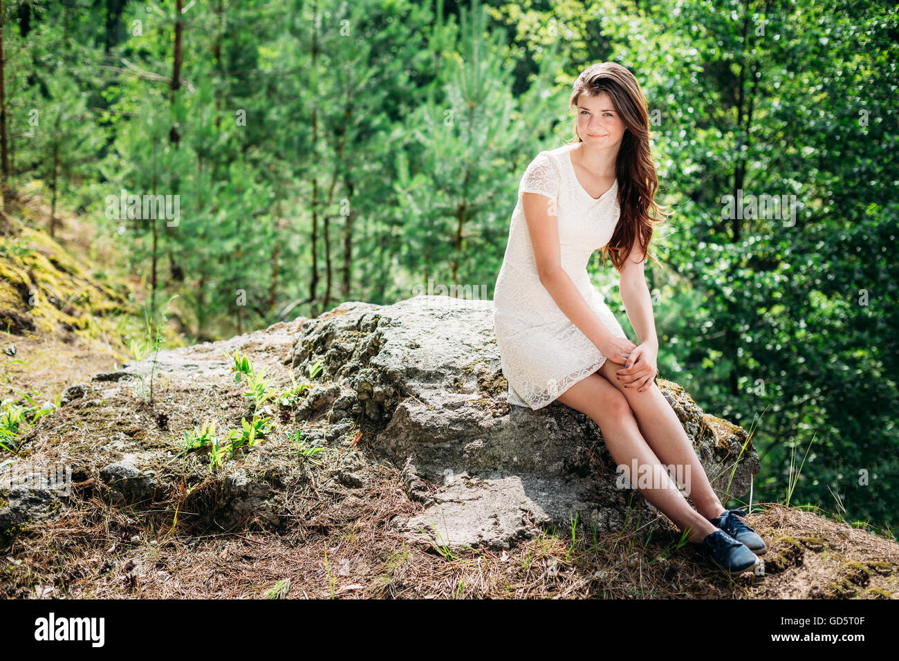 Beautiful Cute Young Smiling Woman Girl In White Dress Sitting On Stone In Summer Forest Stock