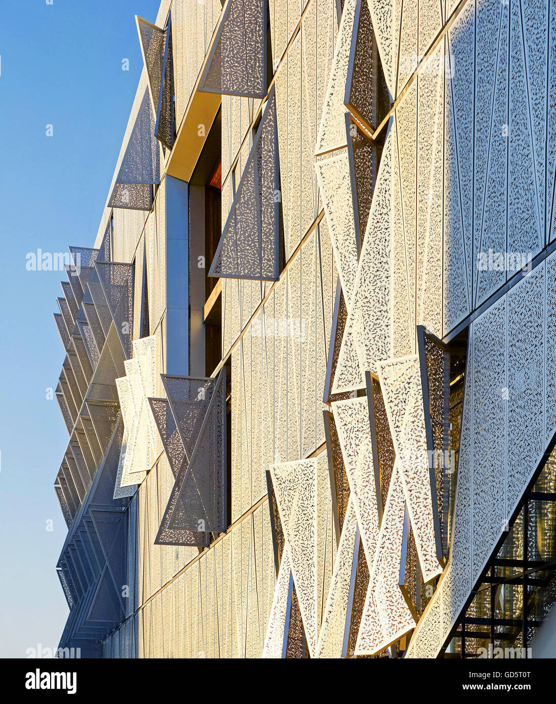 Exterior facade with adjustable triangular perforated steel shutters ...