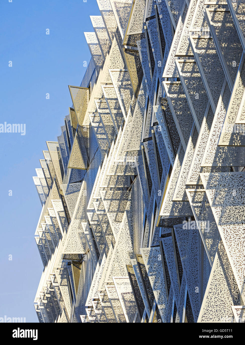 Exterior facade with adjustable triangular perforated steel shutters ...