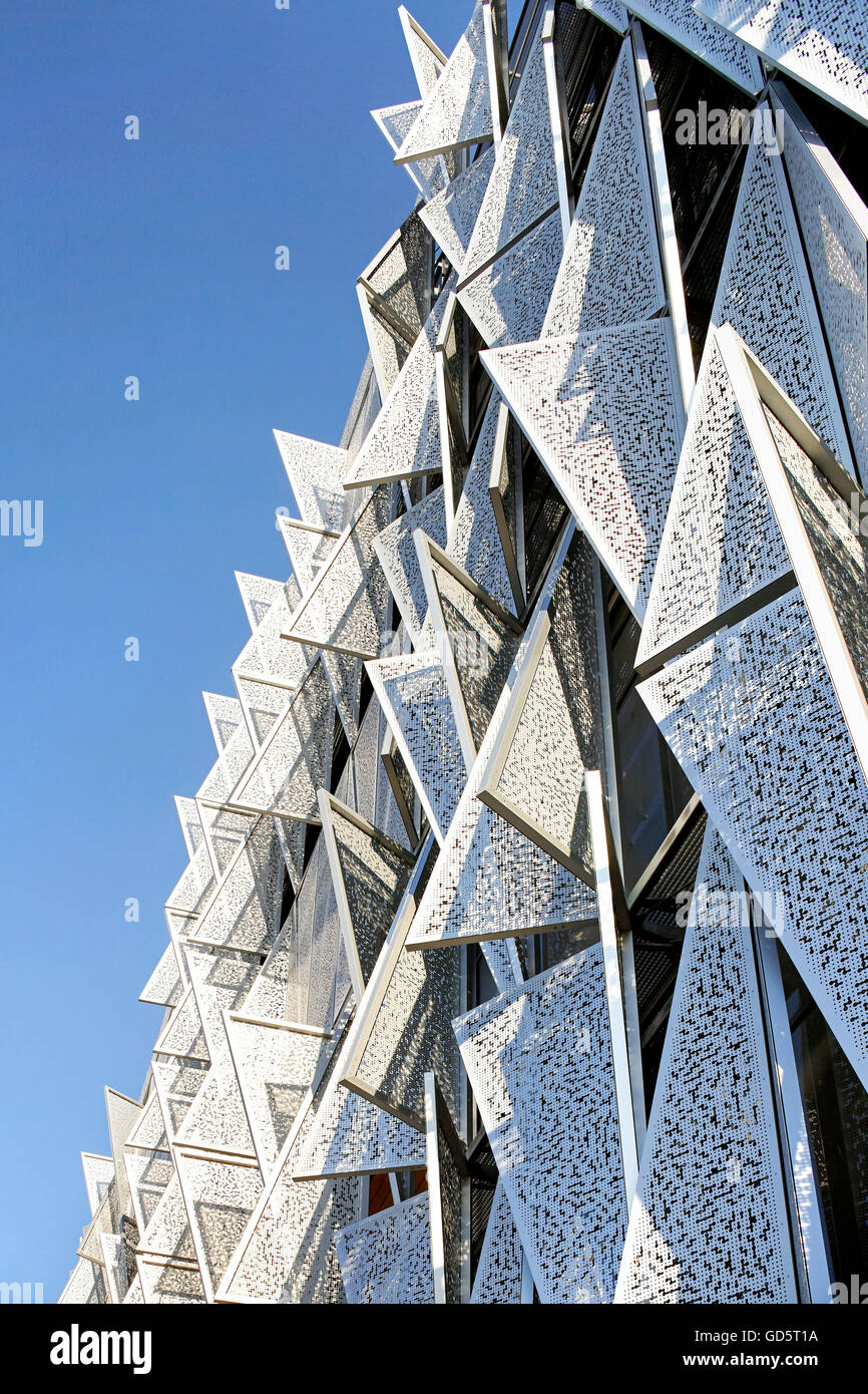 Exterior facade with adjustable triangular perforated steel shutters ...