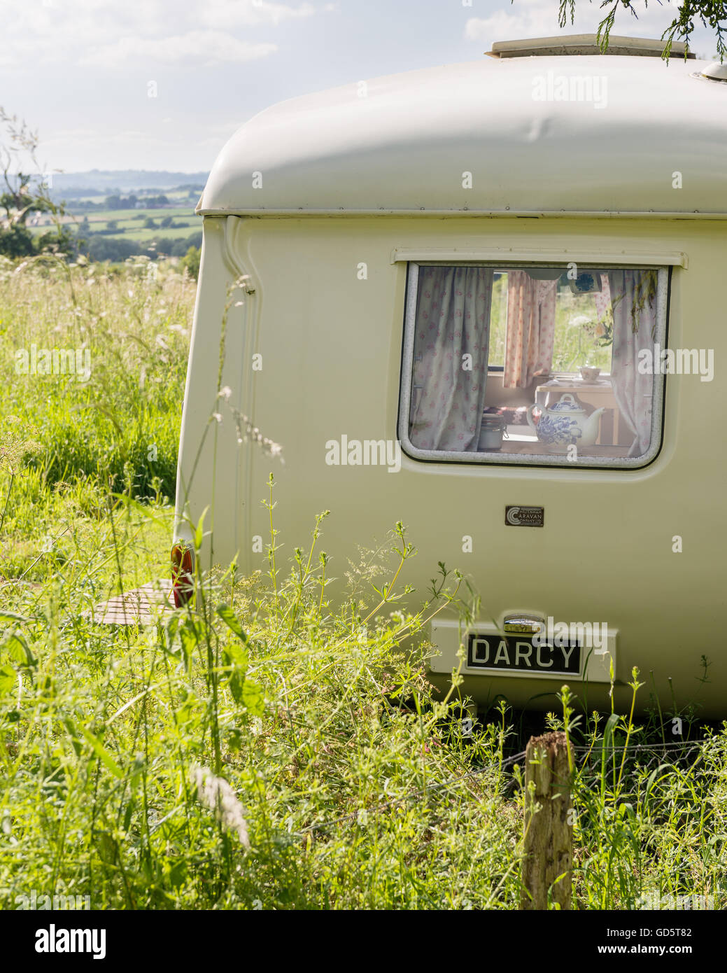 Retro caravan in an english meadow Stock Photo - Alamy