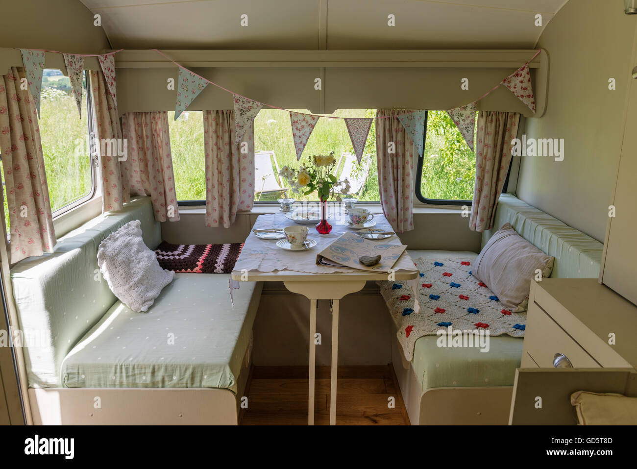 Seating area inside a caravan with retro interior Stock Photo - Alamy
