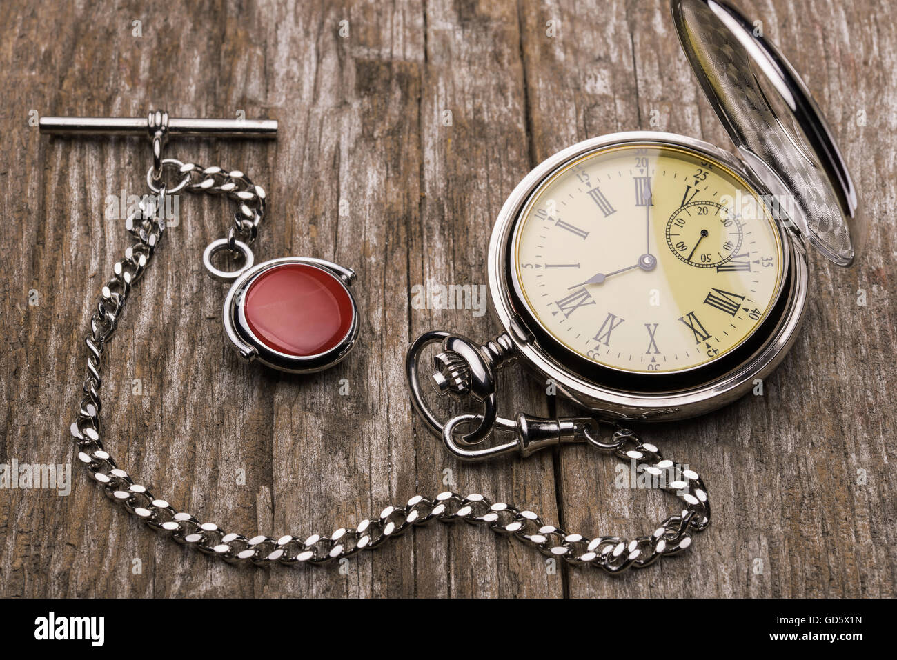 Old fashioned pocket watch with chain on rough wood Stock Photo - Alamy