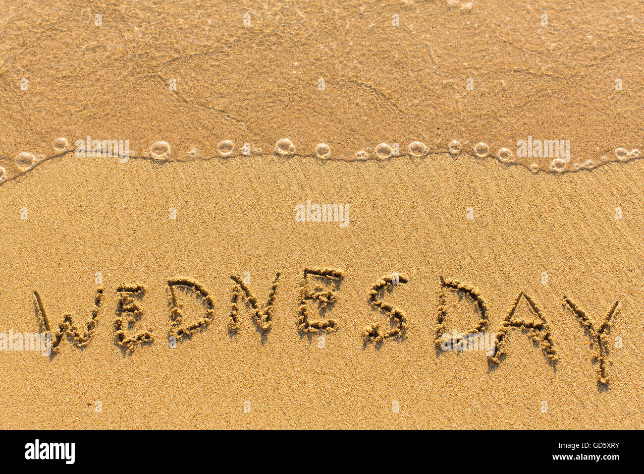 Wednesday - hand-written on the sand in line of the sea surf Stock ...