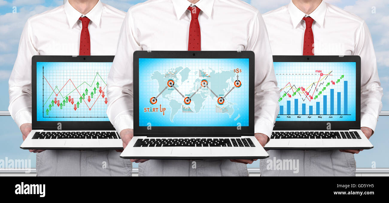 Three businessman standing in office and holding laptop with business ...