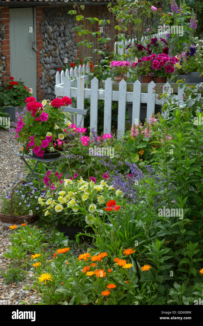 Cottage garden with container planting and white wicket fence Stock ...