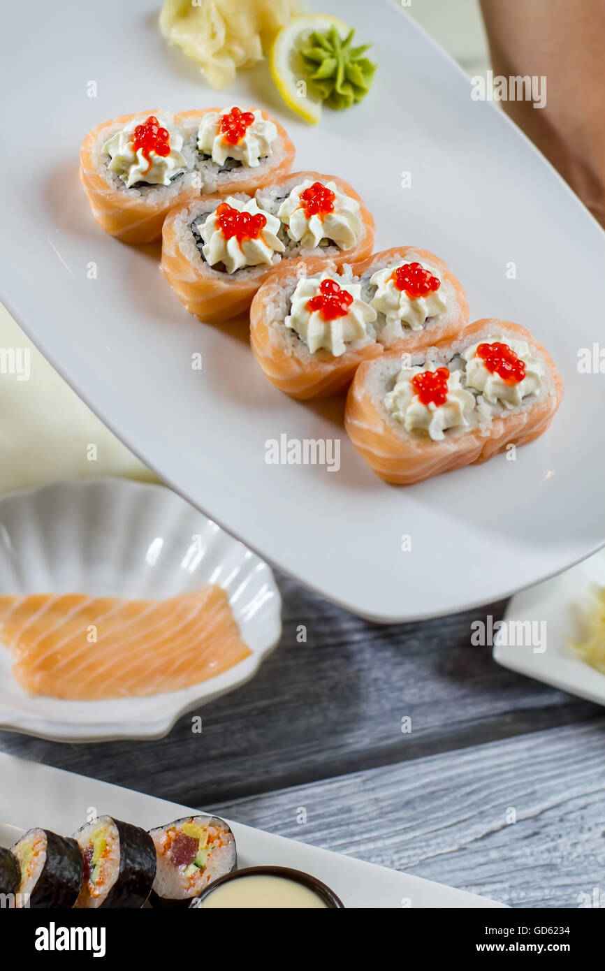 Sushi and wasabi with lemon. Sushi rolls lying on plate. New japanese ...