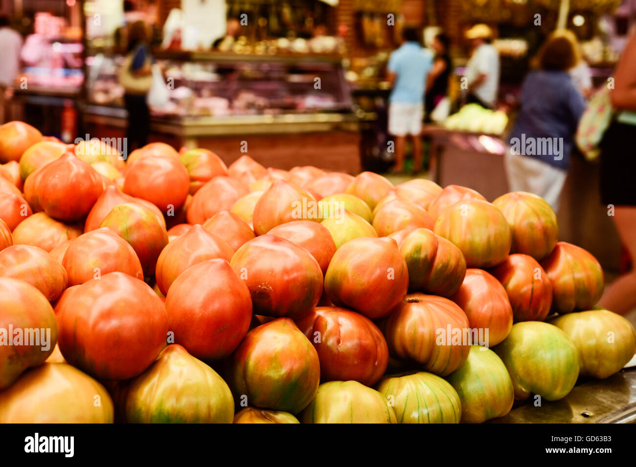 closeup of some tomatoes on sale in a stall in a public market, with ...