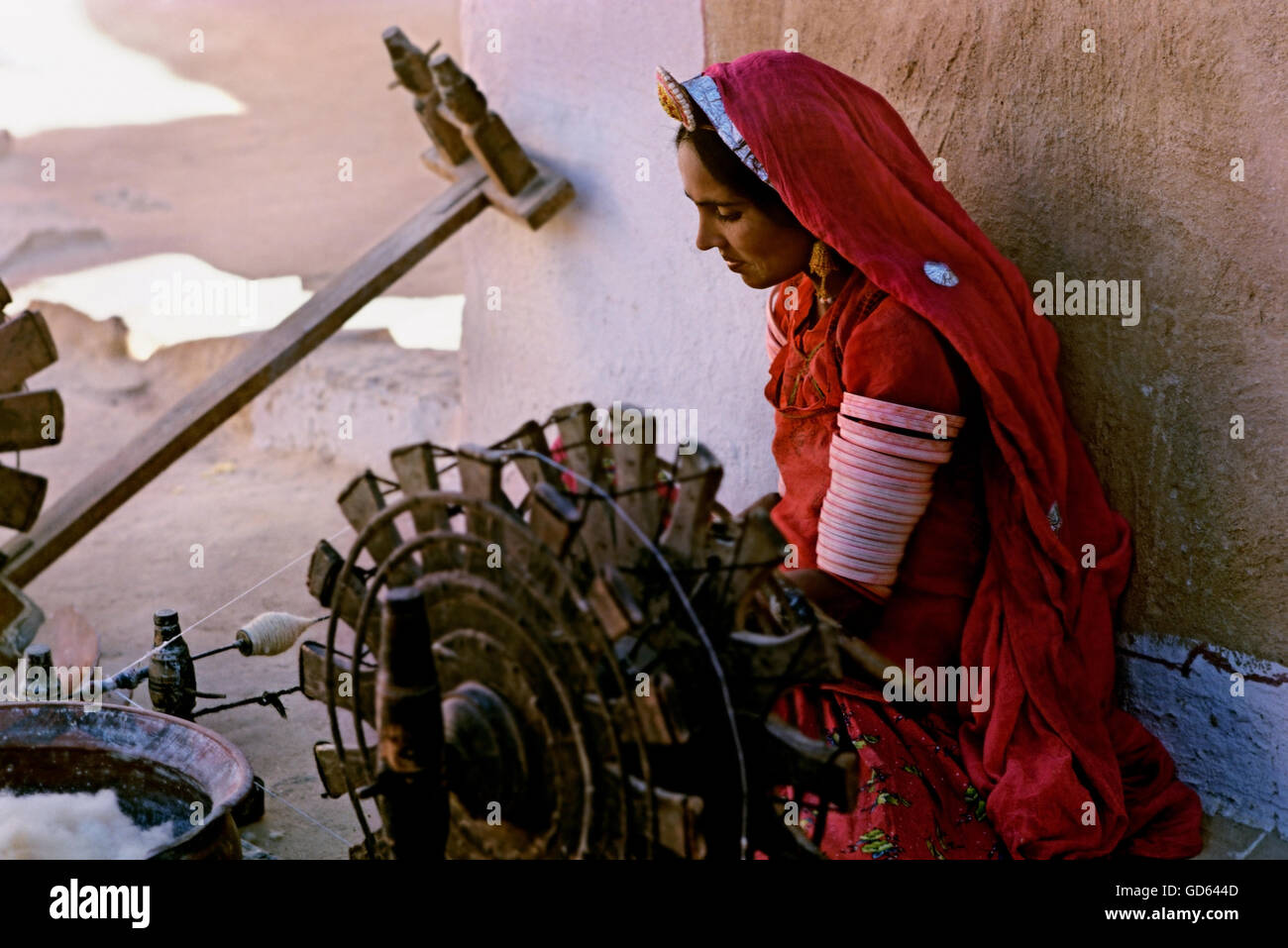 Woman at spinning wheel Stock Photo - Alamy