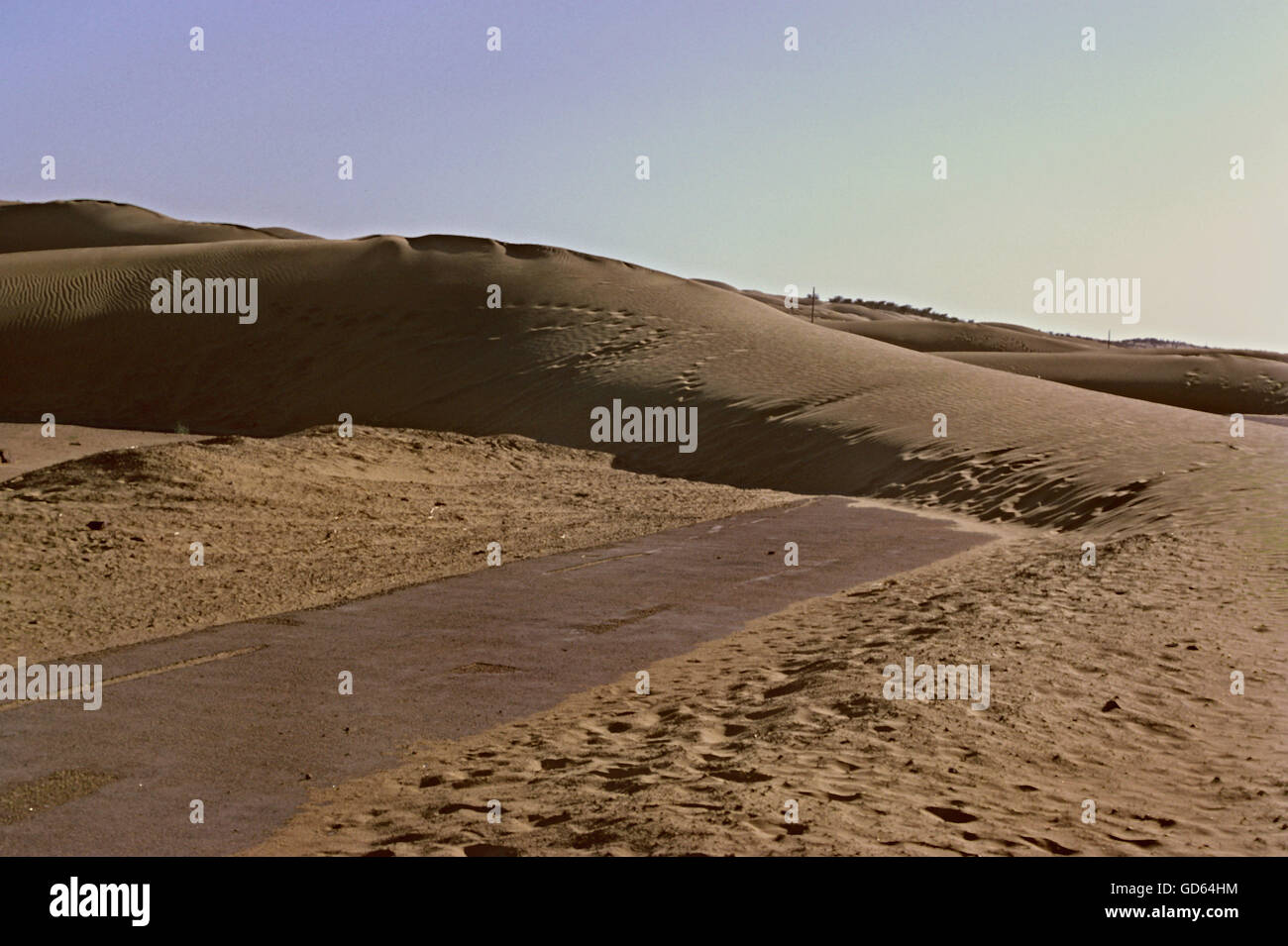 Sand dunes across road Stock Photo - Alamy
