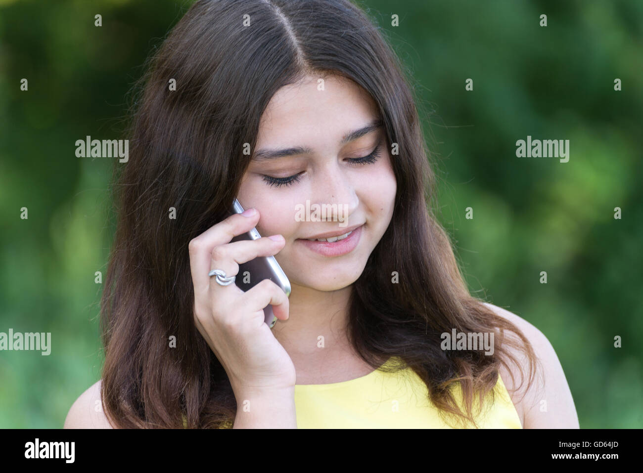 Cute girl talking on phone in park Stock Photo - Alamy