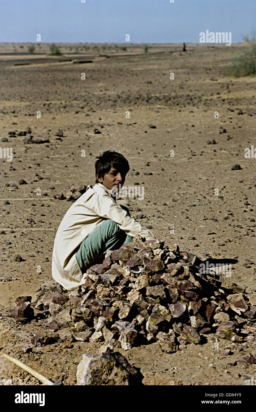 Breaking stones for roads Stock Photo - Alamy