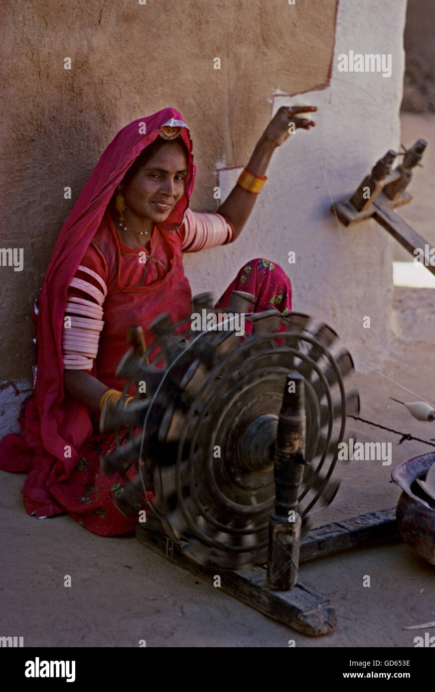 Woman and spinning wheel Stock Photo - Alamy