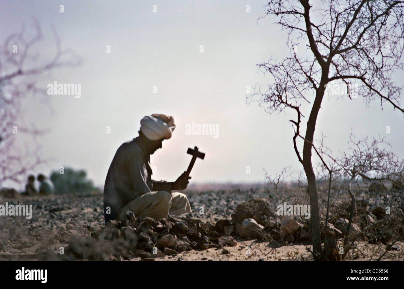 Breaking stones for roads Stock Photo - Alamy