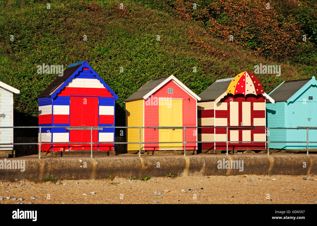 A group of traditional coloured beach huts on the promenade at Cromer ...