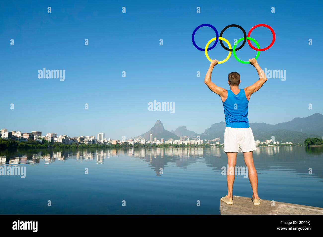 RIO DE JANEIRO - MARCH 27, 2016: Athlete holds Olympic rings at Lagoa ...