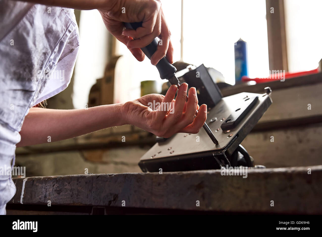 A working woman hands using a screwdriver Stock Photo - Alamy