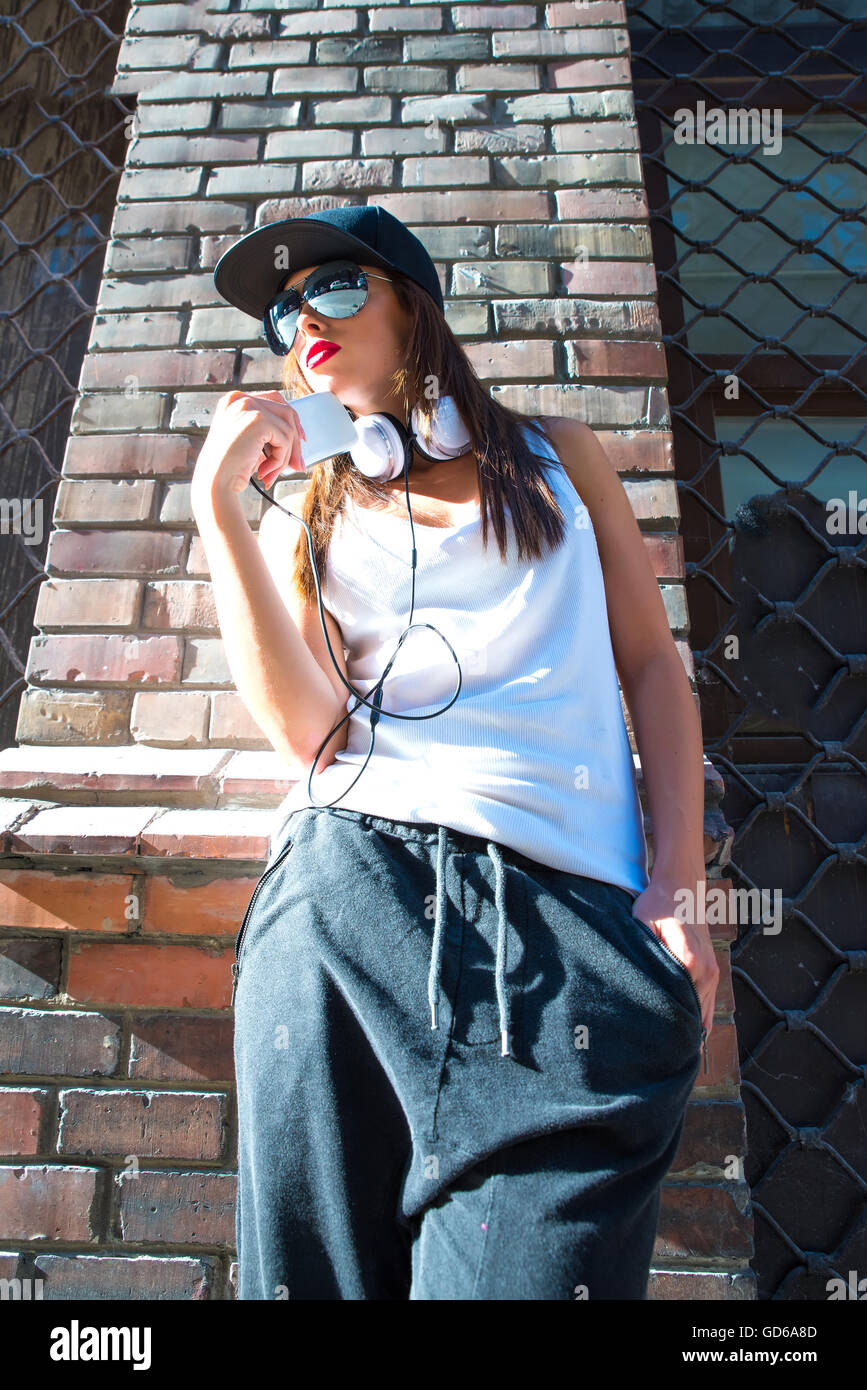 A beautiful young Hip Hop Rapper girl with Headphones in a urban ...