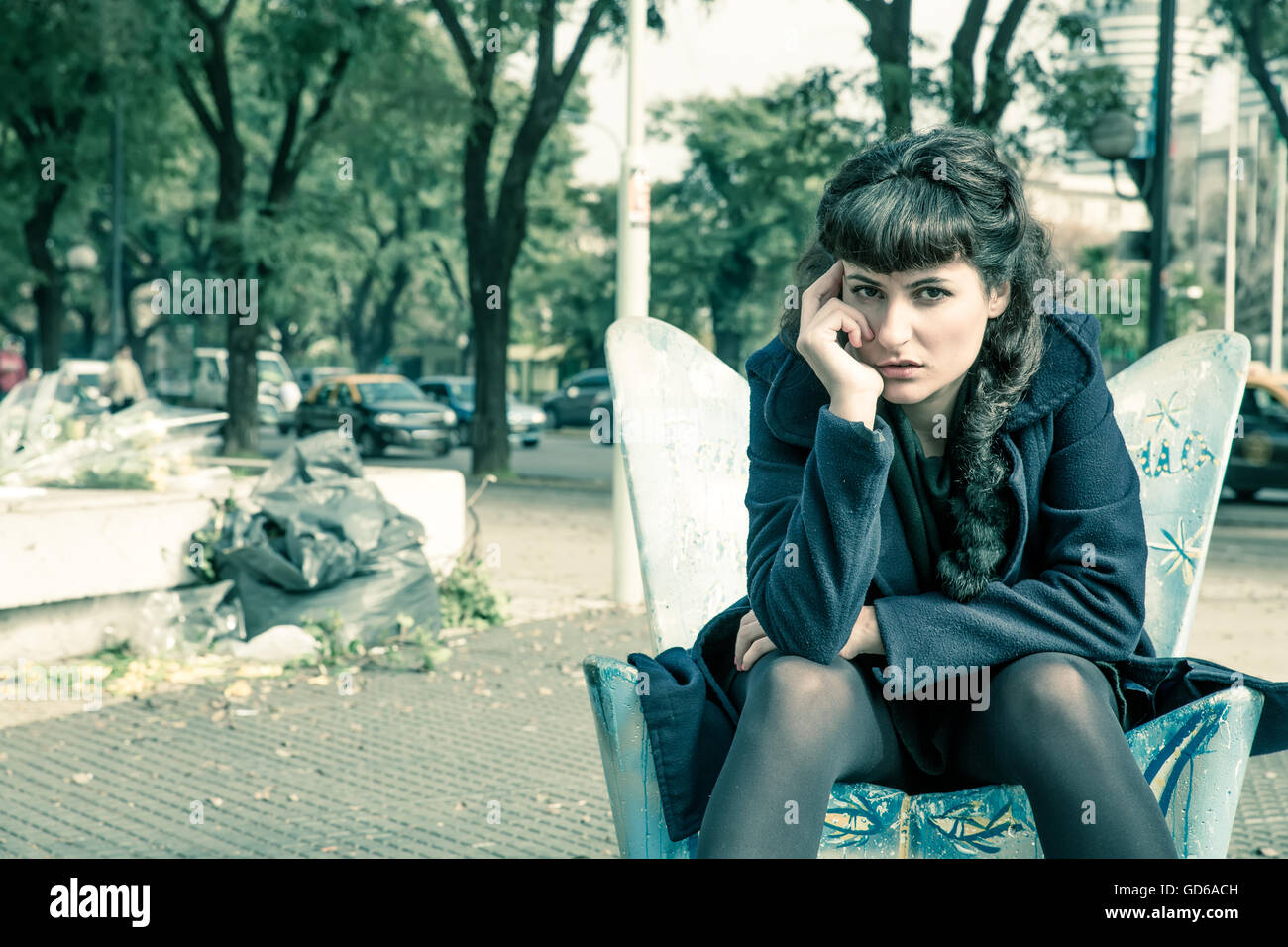 A retro styled girl being bored in a urban environment Stock Photo - Alamy