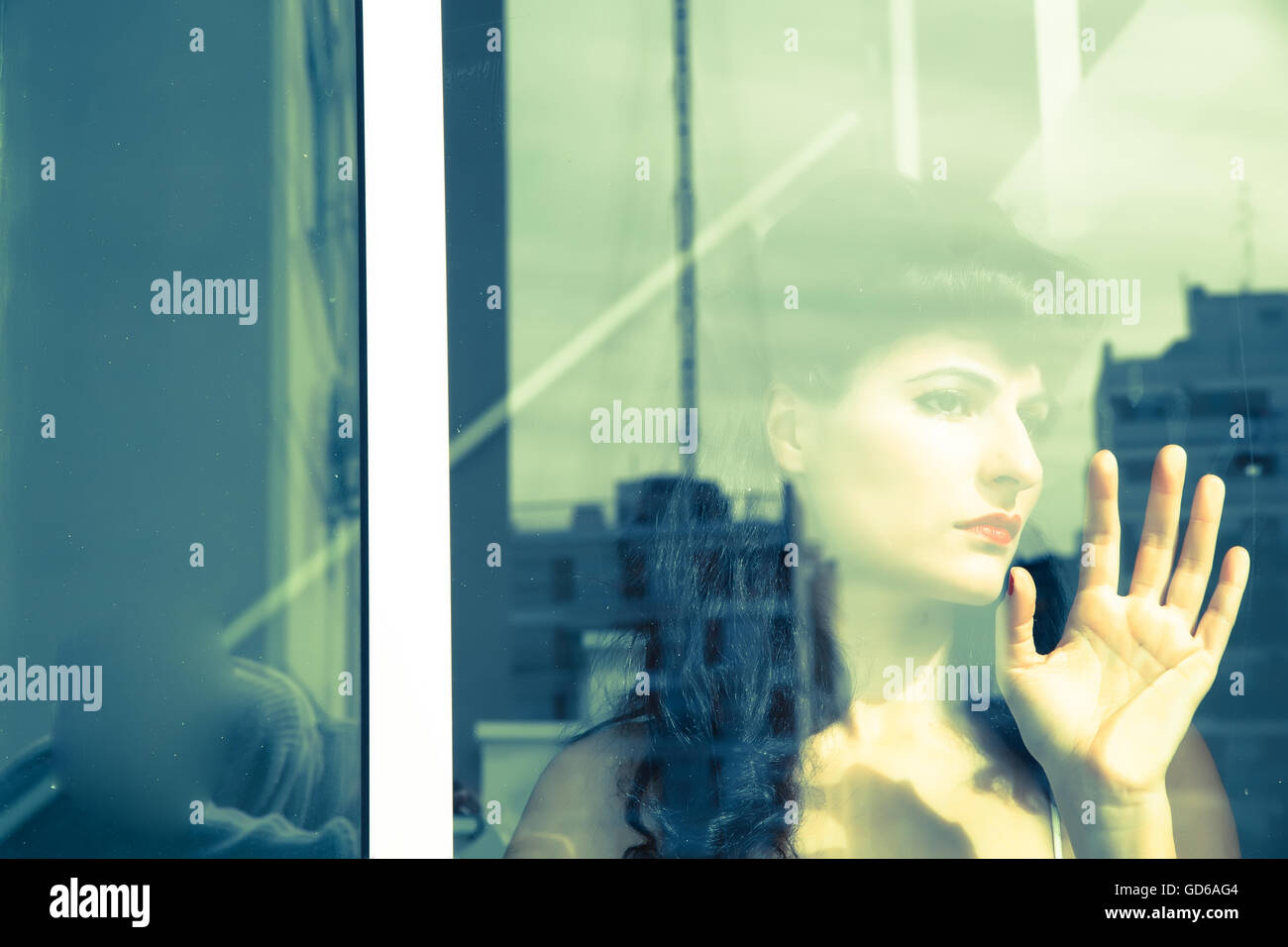 A pensive vintage girl standing behind a window Stock Photo - Alamy