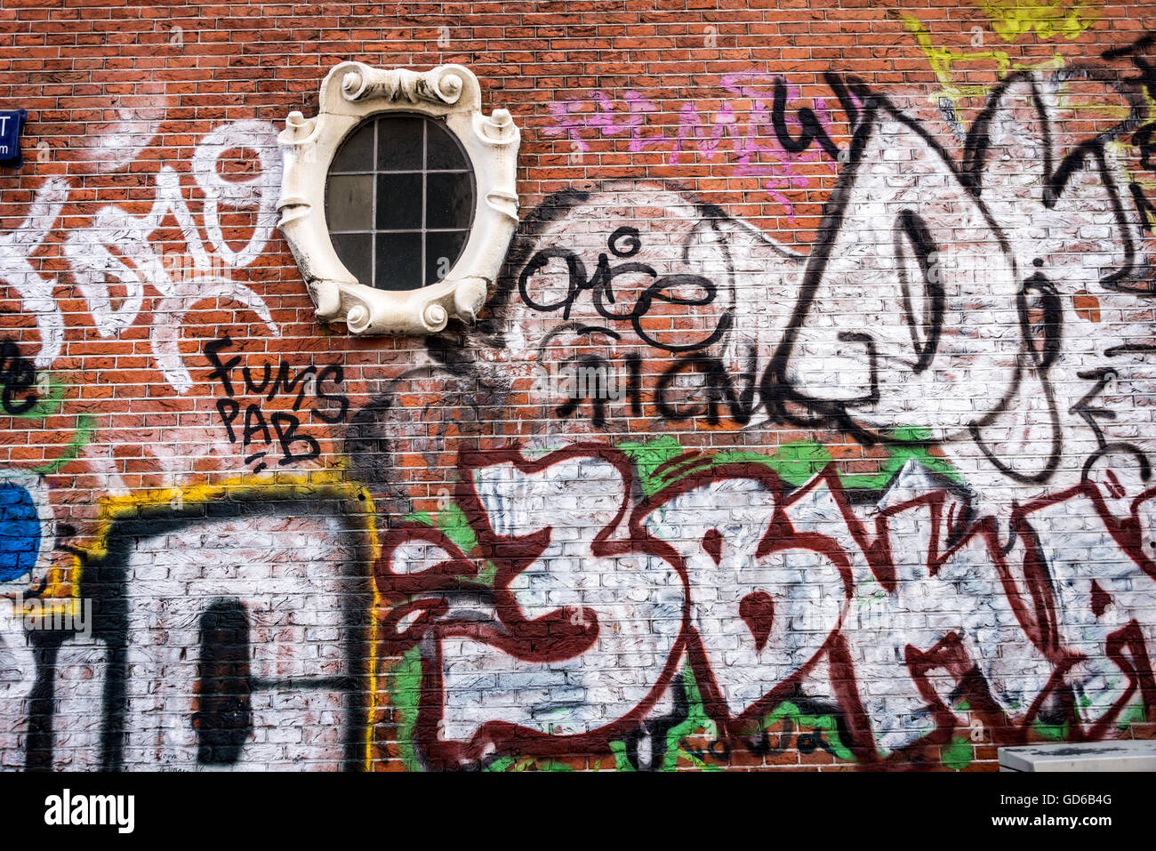 Amsterdam graffiti and classic round window Stock Photo - Alamy