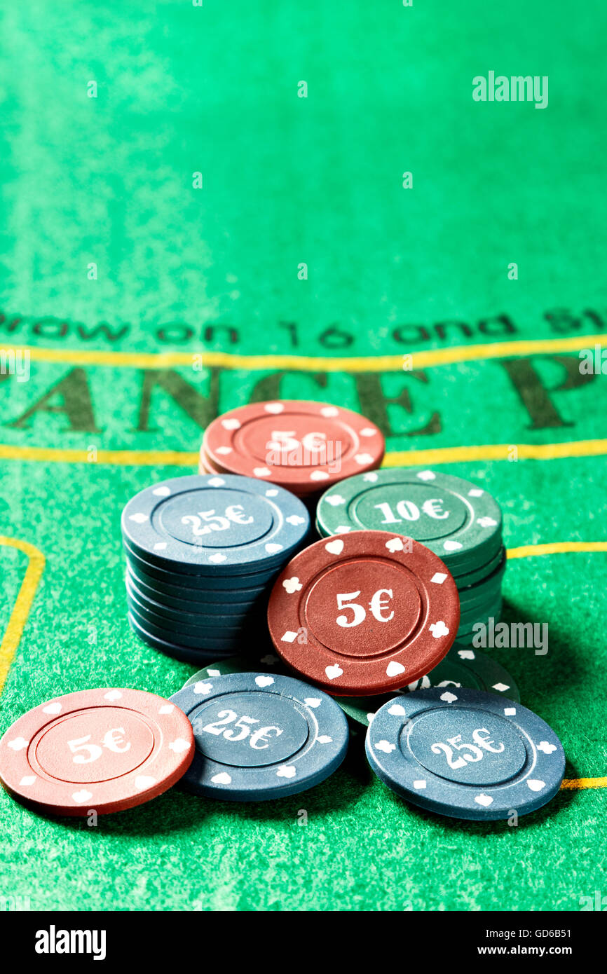 Poker chips on a poker table. Vertical image Stock Photo - Alamy